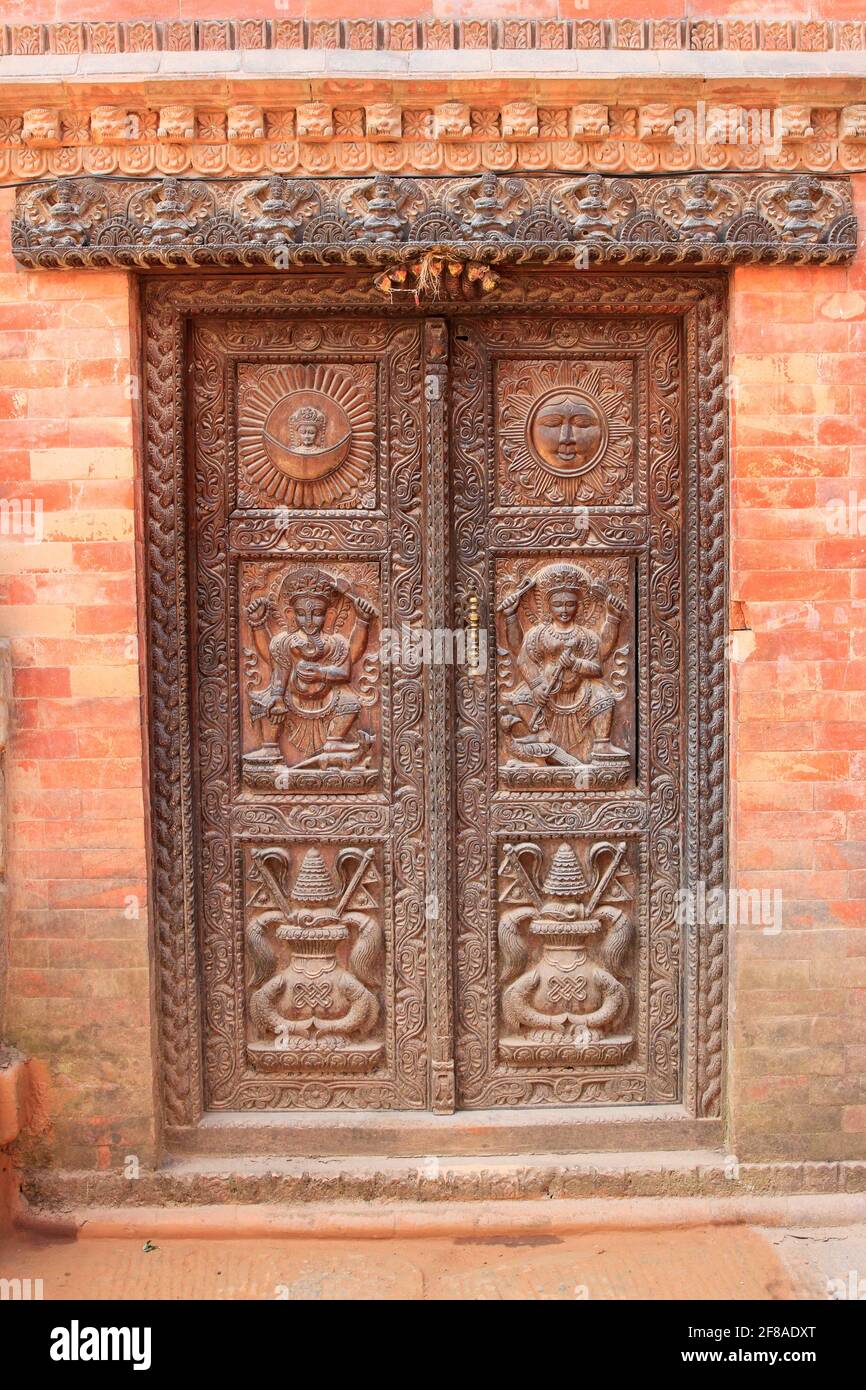 Carved wooden door in brick building in Bhaktapur, Nepal Stock Photo ...