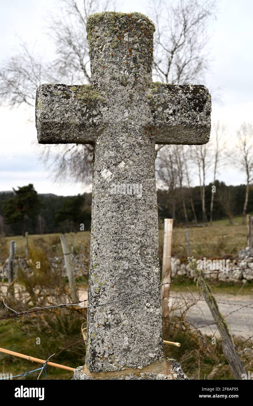 Granite stone christian cross in a green field Stock Photo - Alamy