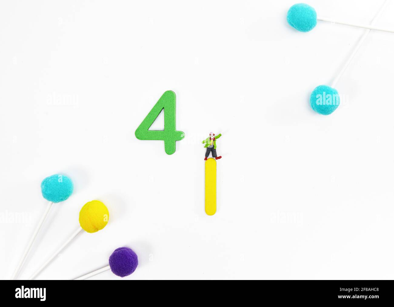 Clown figurine standing on number 1 with number 4 and lollipops ...