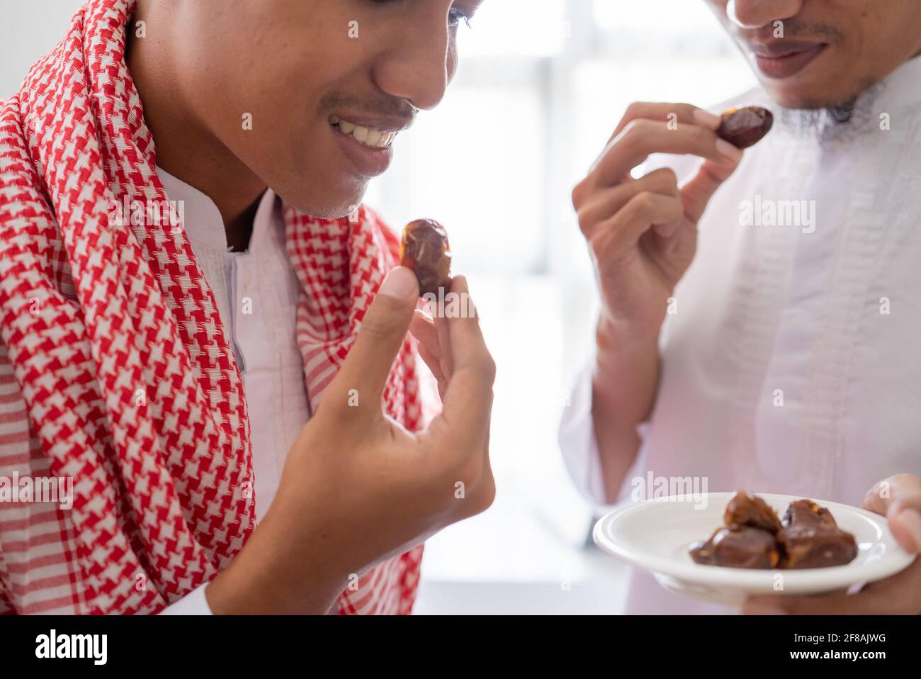 muslim sharing a bowl of dates while enjoying iftar dinner together ...