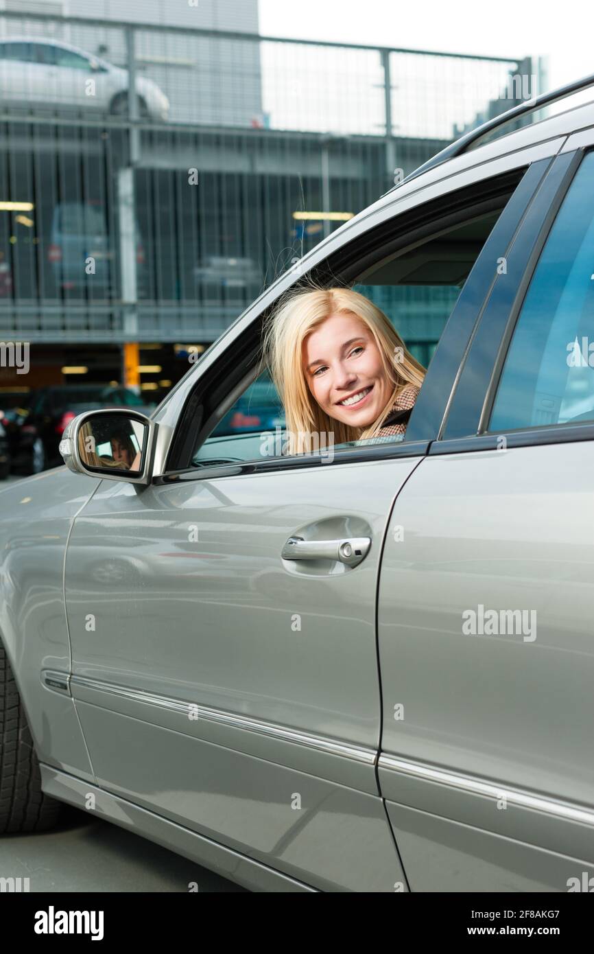 Woman back her car on a parking level or parking deck Stock Photo - Alamy