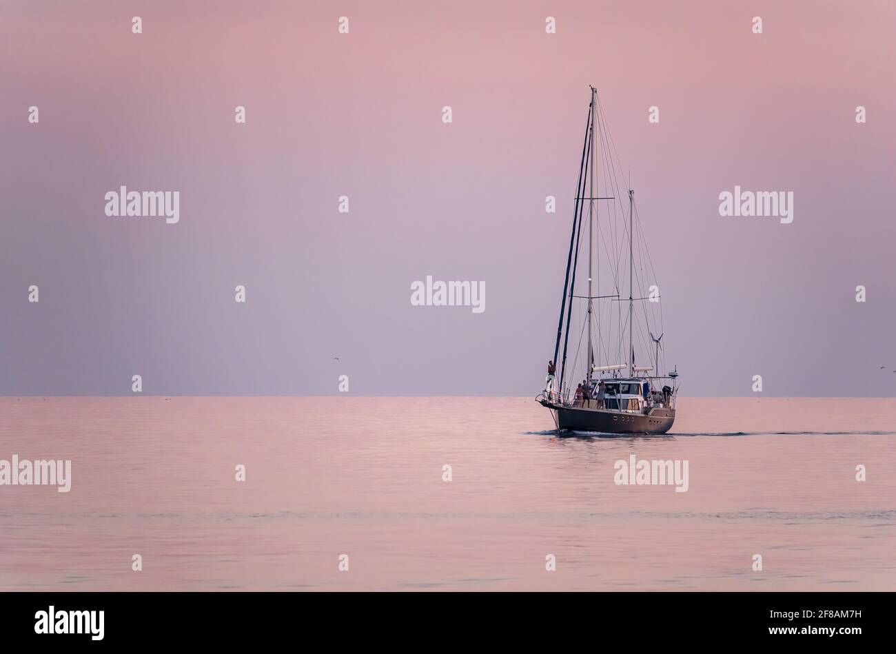 Sailing yacht in the blue sea during beautiful pink sunset. A yacht in ...