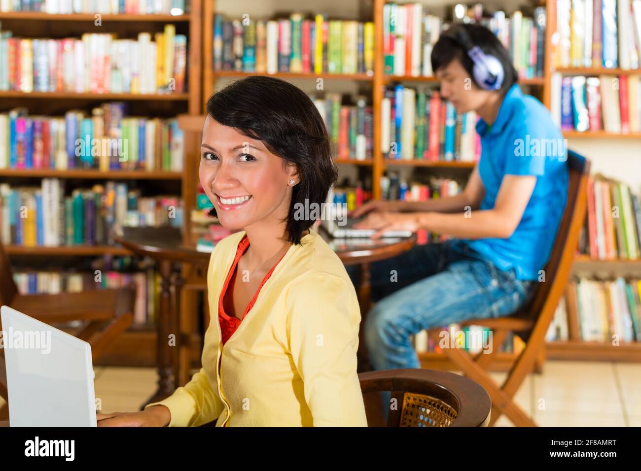 Students write in library learning on the Laptop - Portrait of a female ...