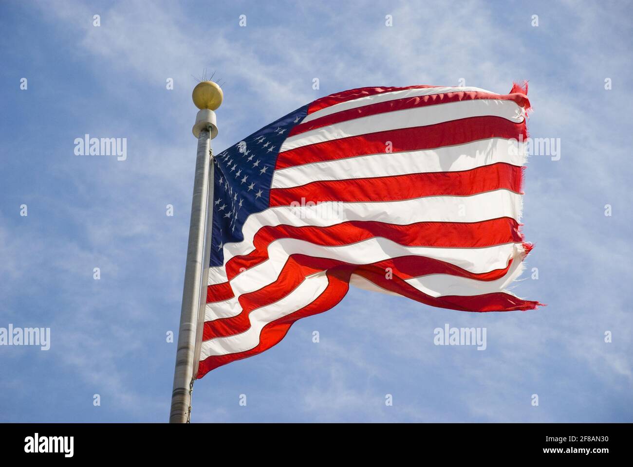 American Flag on a pole waving in wind Stock Photo - Alamy