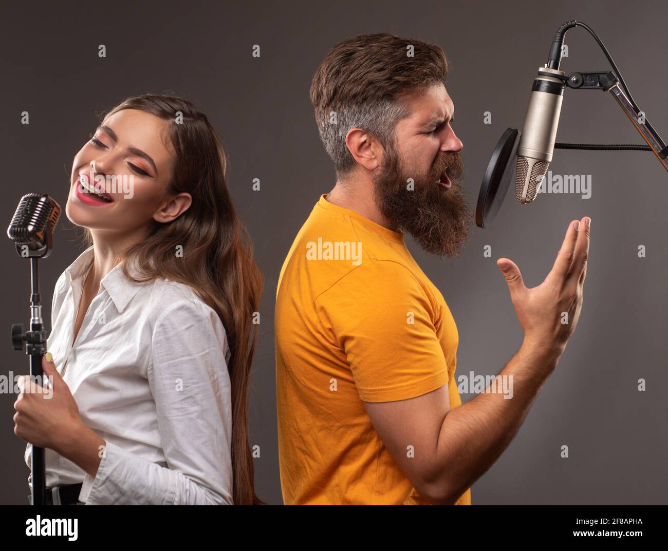 Happy couple in recording studio. Music performance vocal. Singer ...