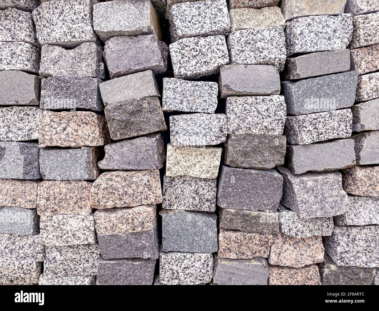 stack natural granite stones for sidewalk construction. building ...