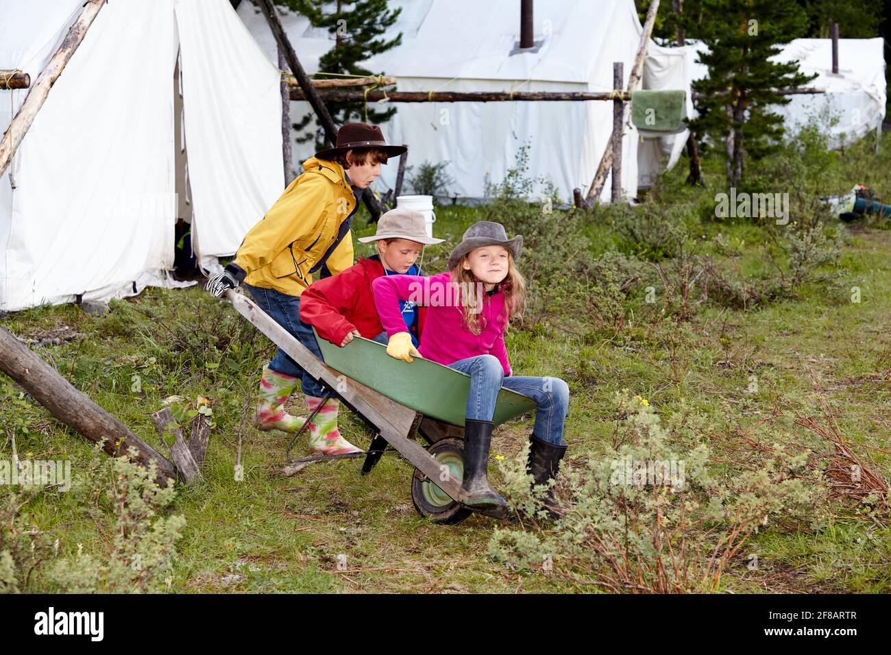 Children playing in a wheelbarrow Stock Photo - Alamy