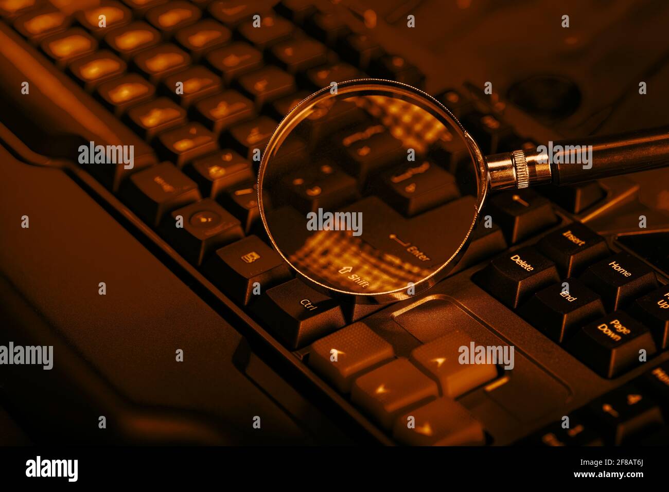 Personal computer keyboard with magnifying glass, online security and ...