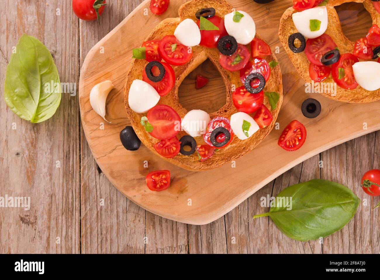 Friselle with tomatoes and mozzarella cheese Stock Photo - Alamy