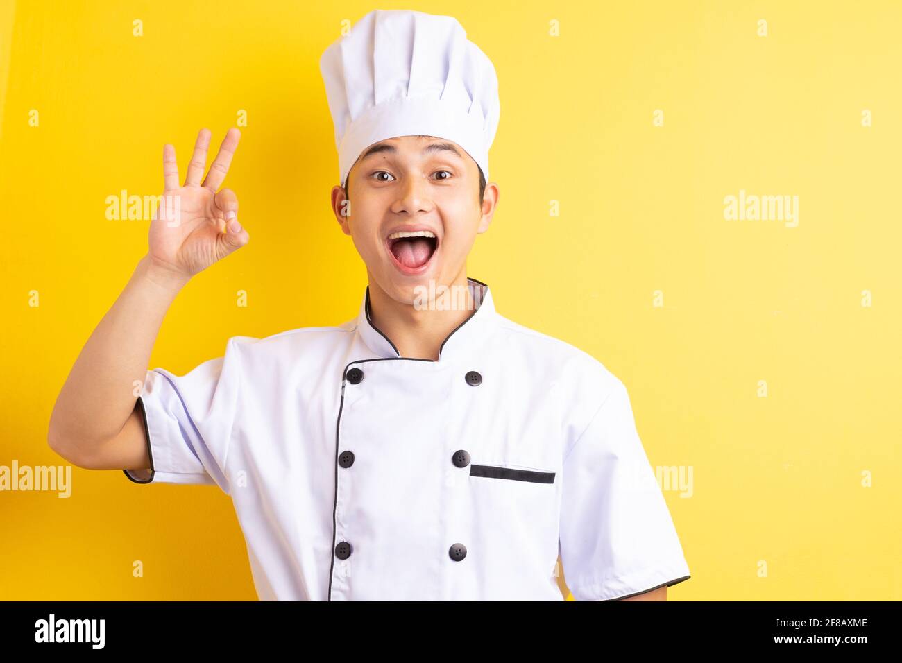 Image of Asian male chef on yellow background Stock Photo - Alamy