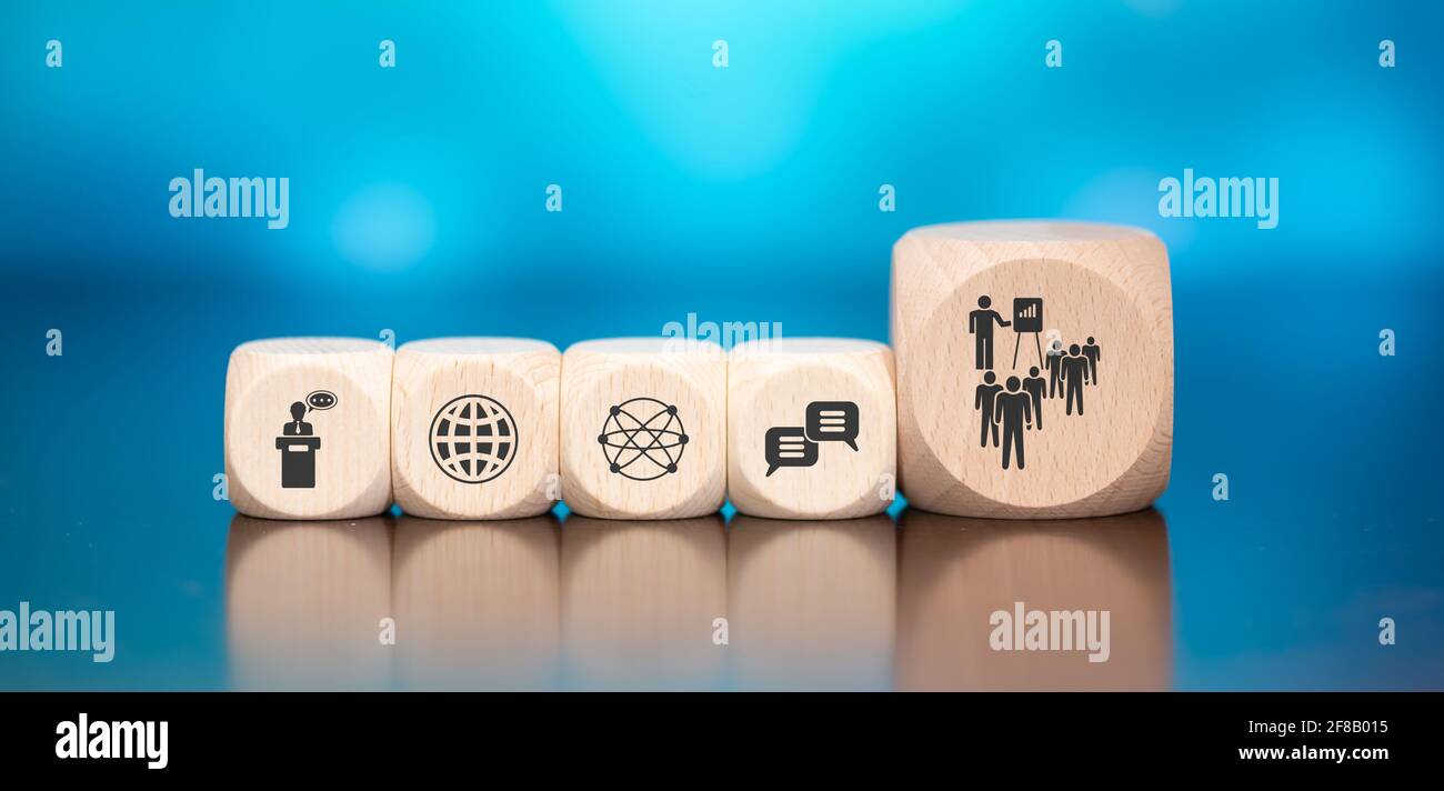 Wooden blocks with symbol of seminar meeting concept on blue background ...