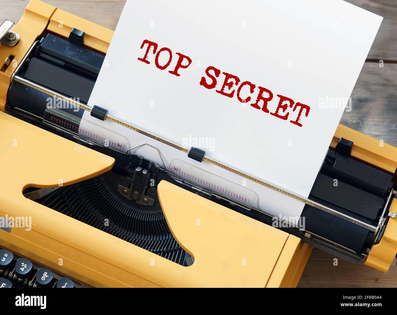 Top Secret on a white sheet of paper in old yellow typewriter Stock ...