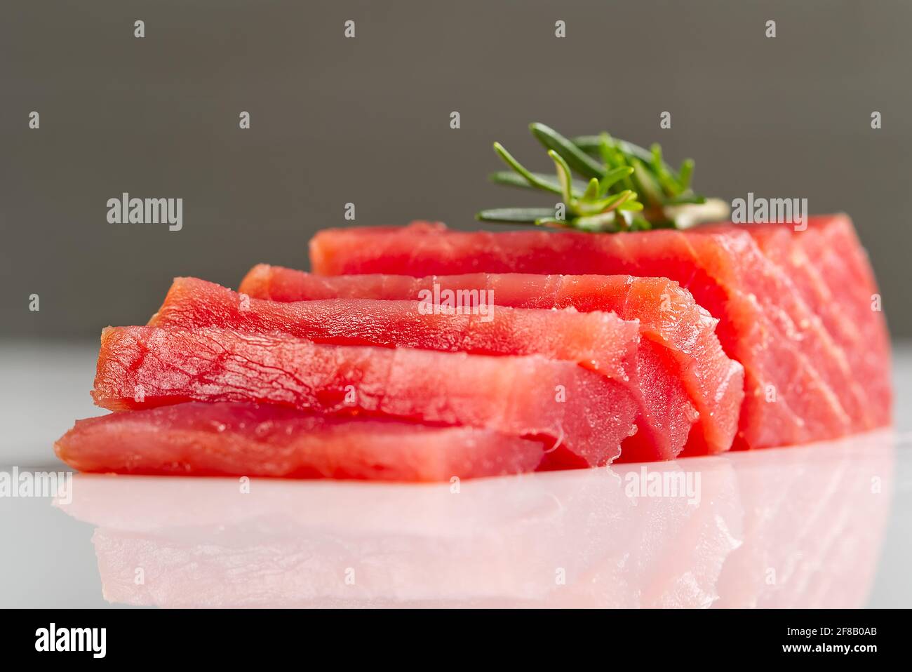 tuna sashimi. fresh yellowfin sliced tuna steak a white table. bluefin ...