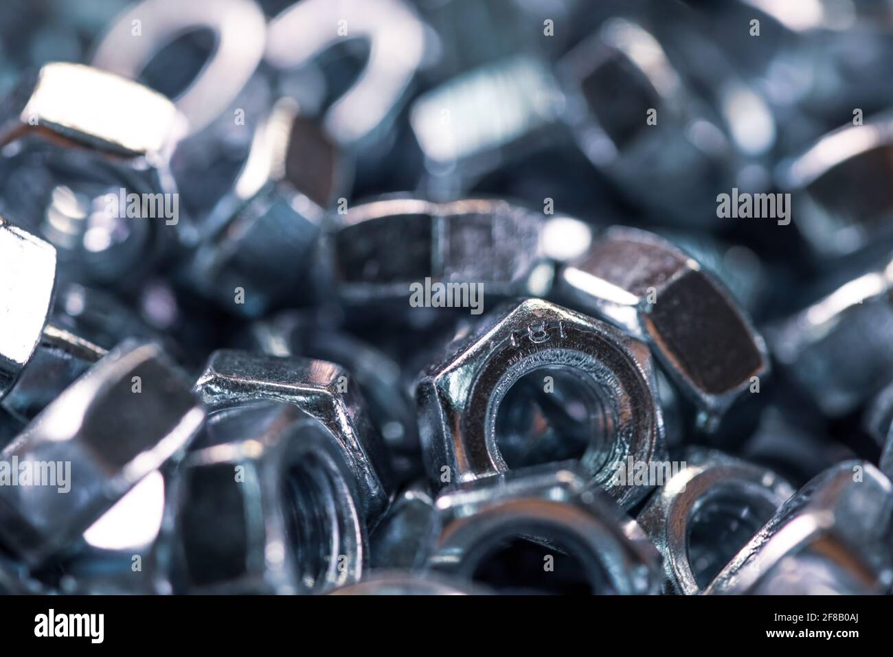 Metal chrome nuts in a chaotic order industrial background Stock Photo ...