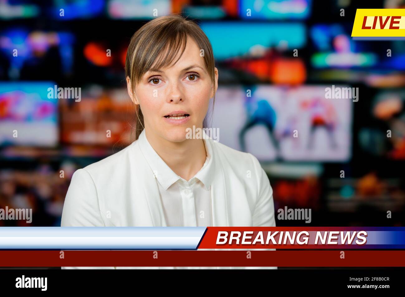 An anchorwoman reporting live breaking news sitting in Tv studio ...