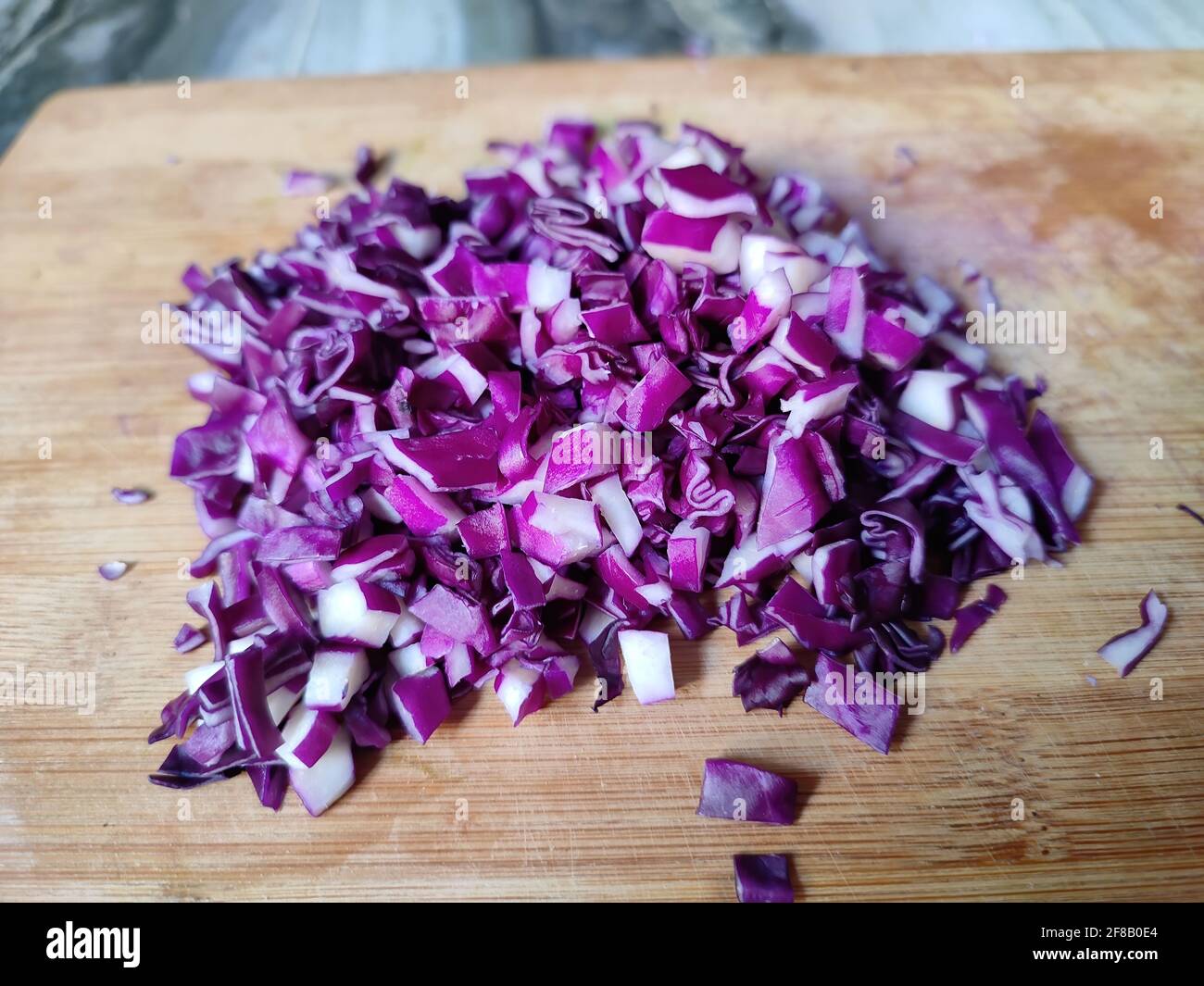 Closeup of chopped red cabbage on a wooden cutting board Stock Photo ...