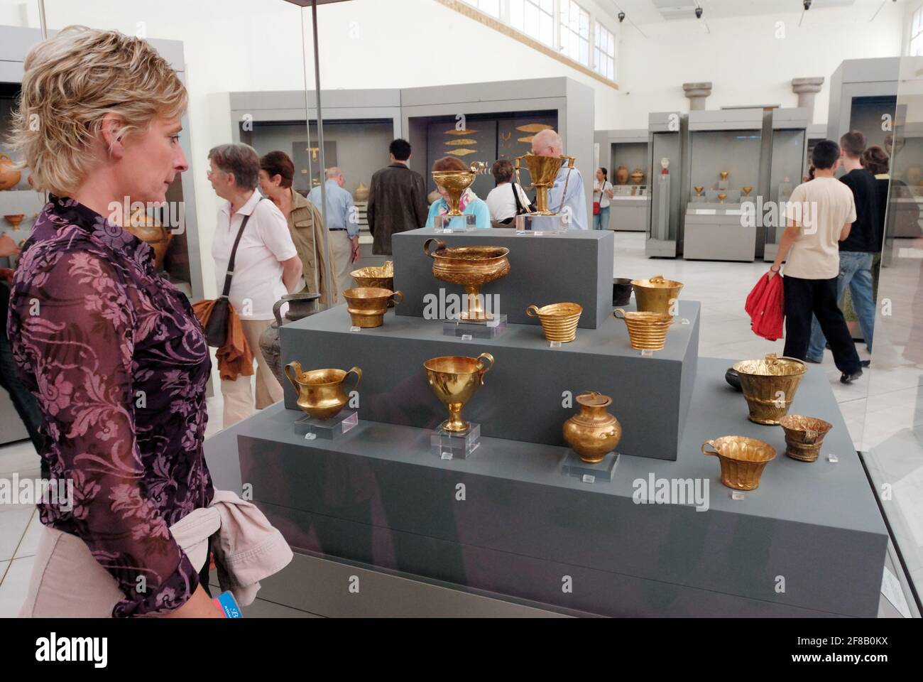 Visitor looks at gold vessels in a showcase, National Archaeological ...
