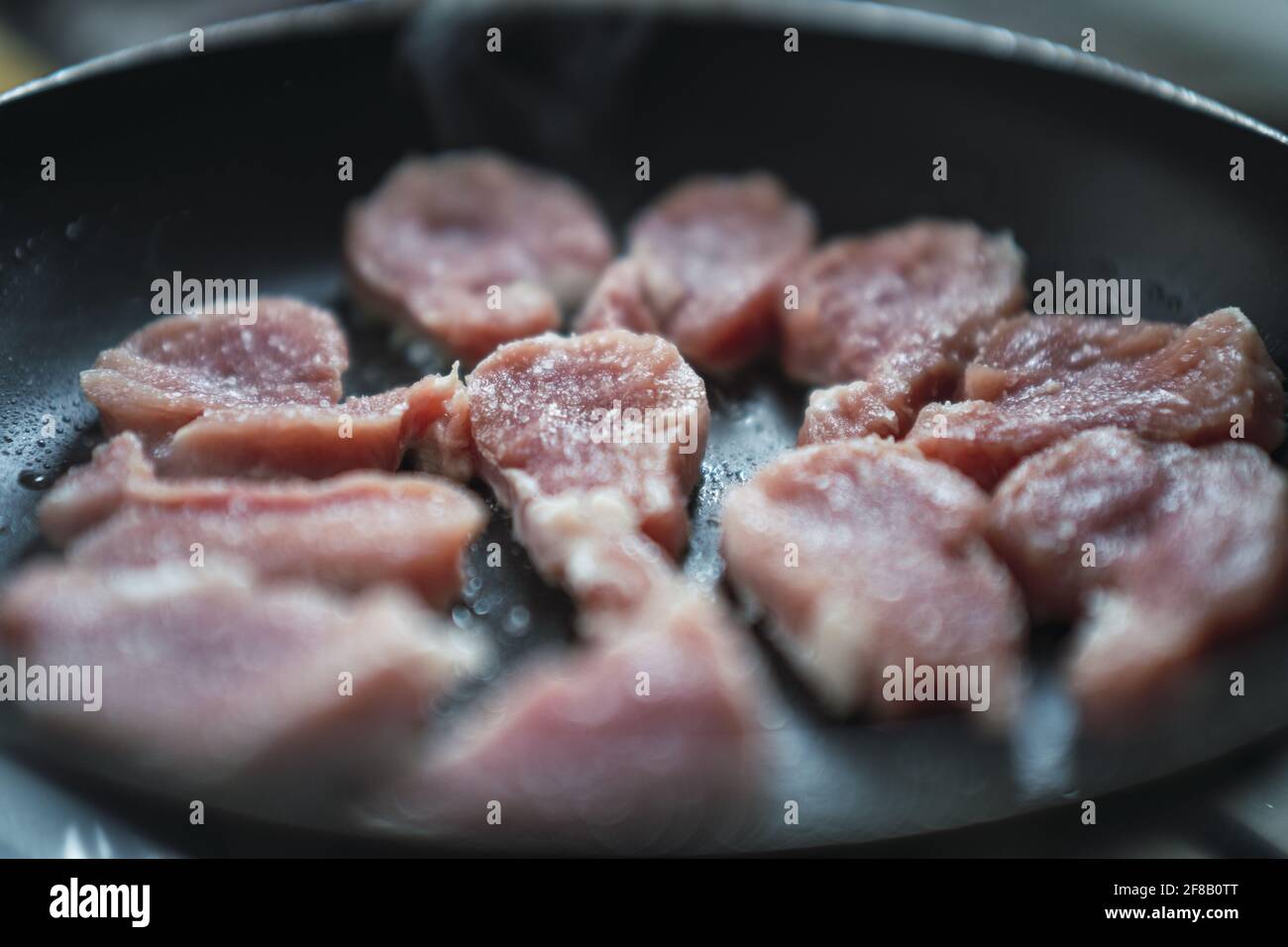 Macro shot of cuts of pork tenderloin cooking in a pan Stock Photo - Alamy