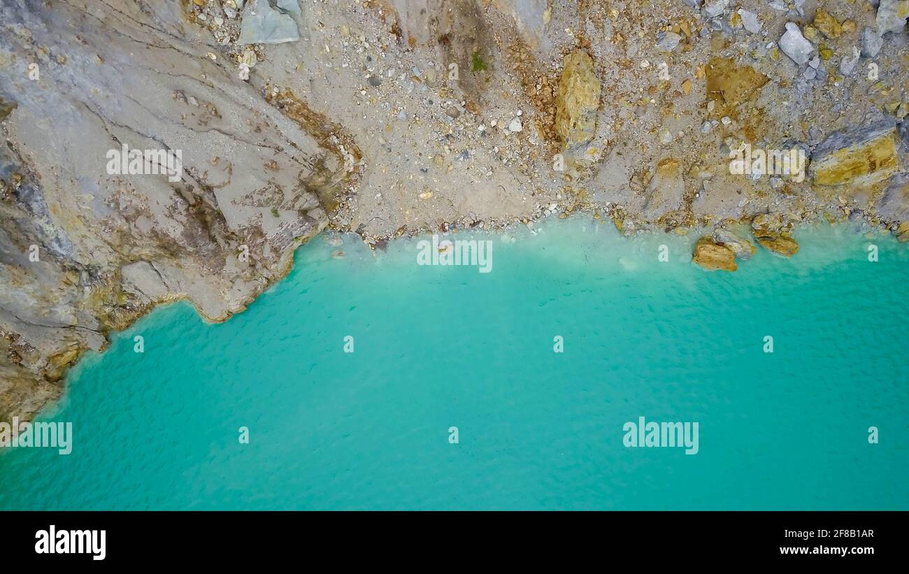 A close up view of the surface of Lake Alapolo and the crater wall ...