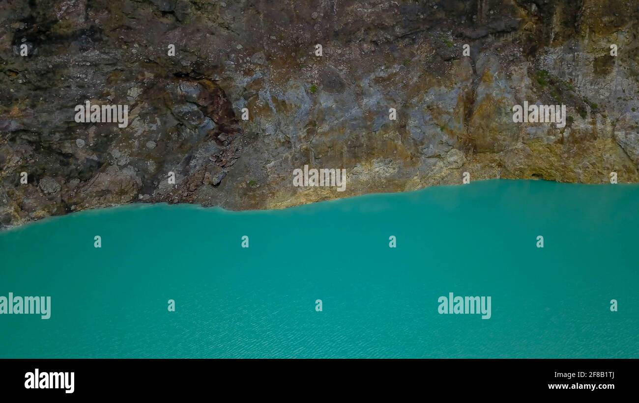 A close up view of the surface of Lake Alapolo and the crater wall ...