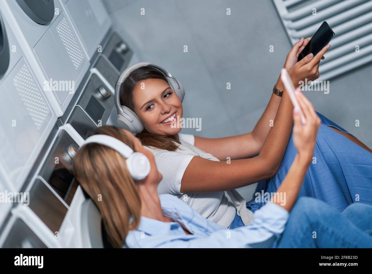 Two students in laundry room Stock Photo - Alamy
