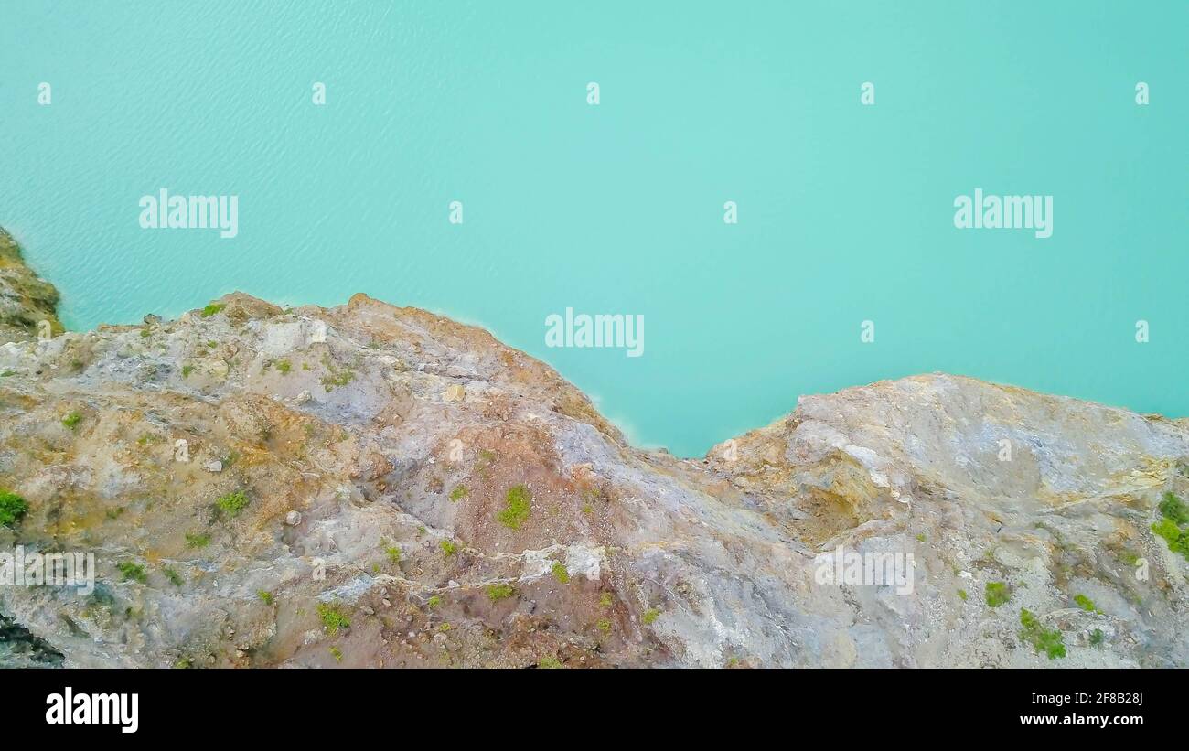 A close up view of the surface of Lake Alapolo and the crater wall ...