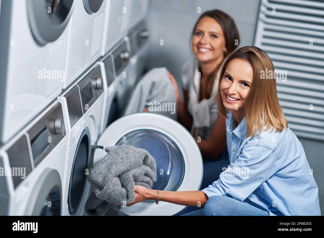 Two students in laundry room Stock Photo - Alamy