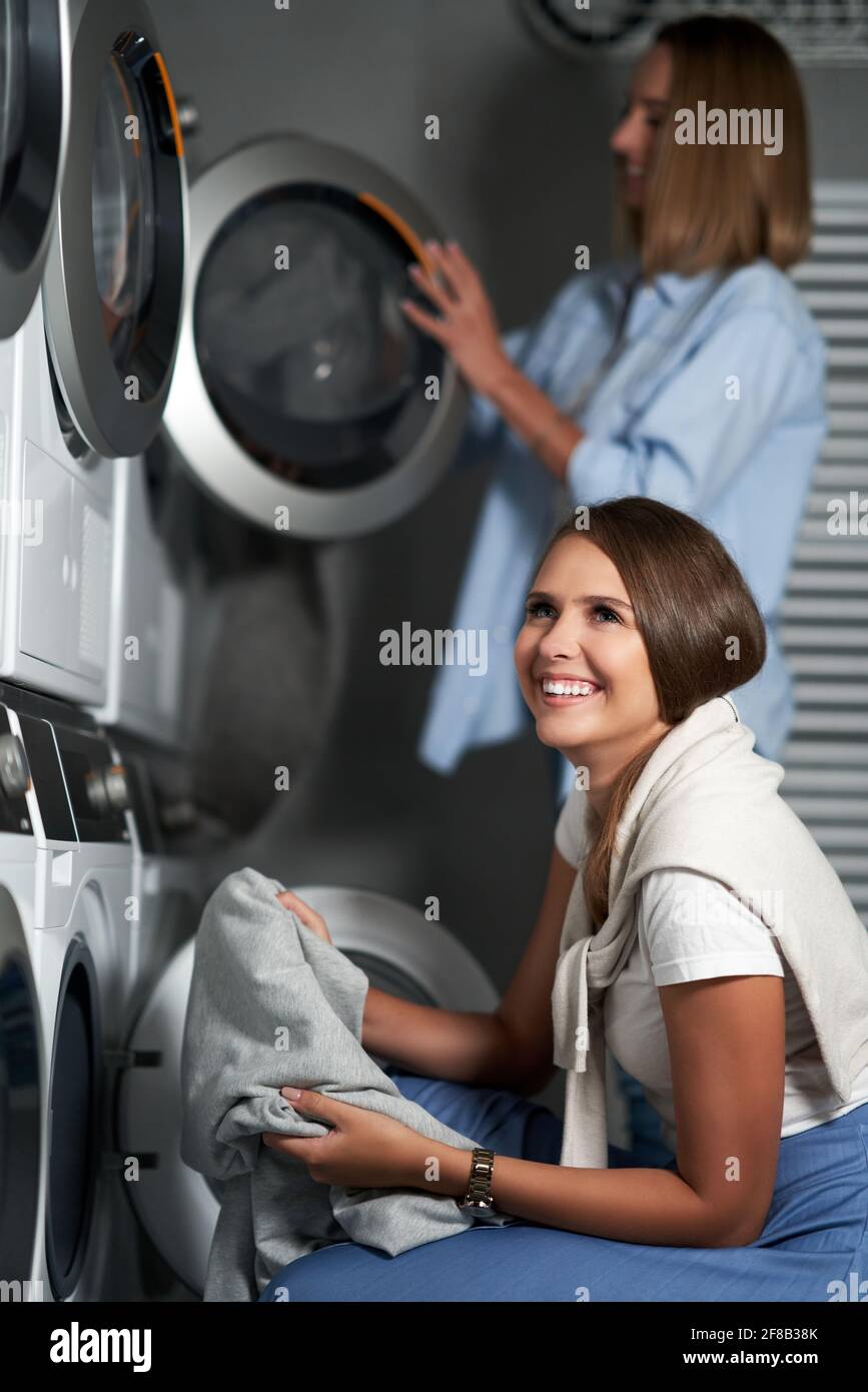 Two students in laundry room Stock Photo - Alamy