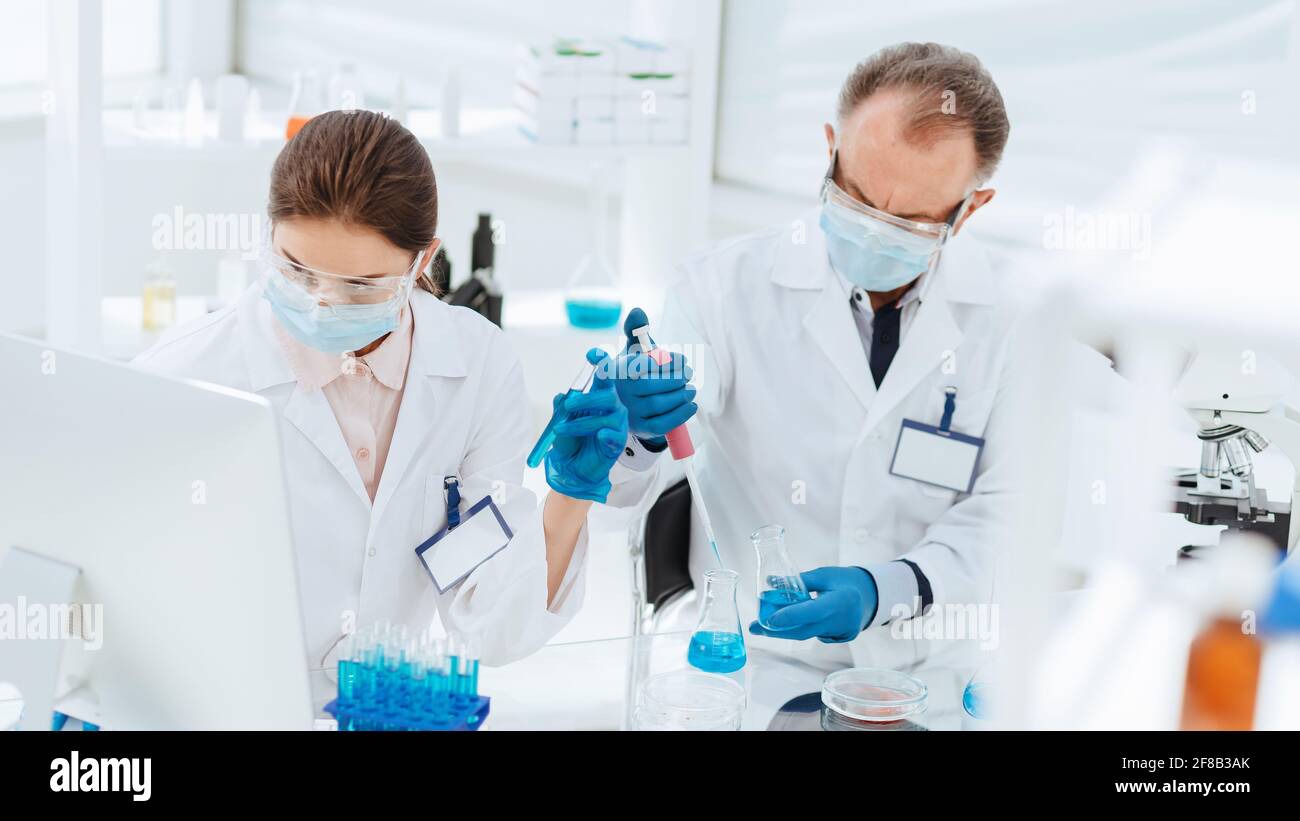 through the glass. scientists work in a medical laboratory Stock Photo ...