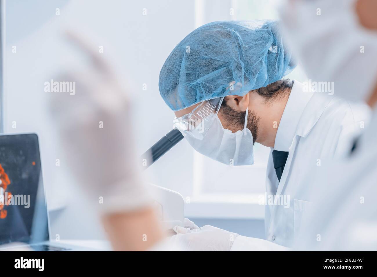 close up. a group of doctors and scientists work in the laboratory ...