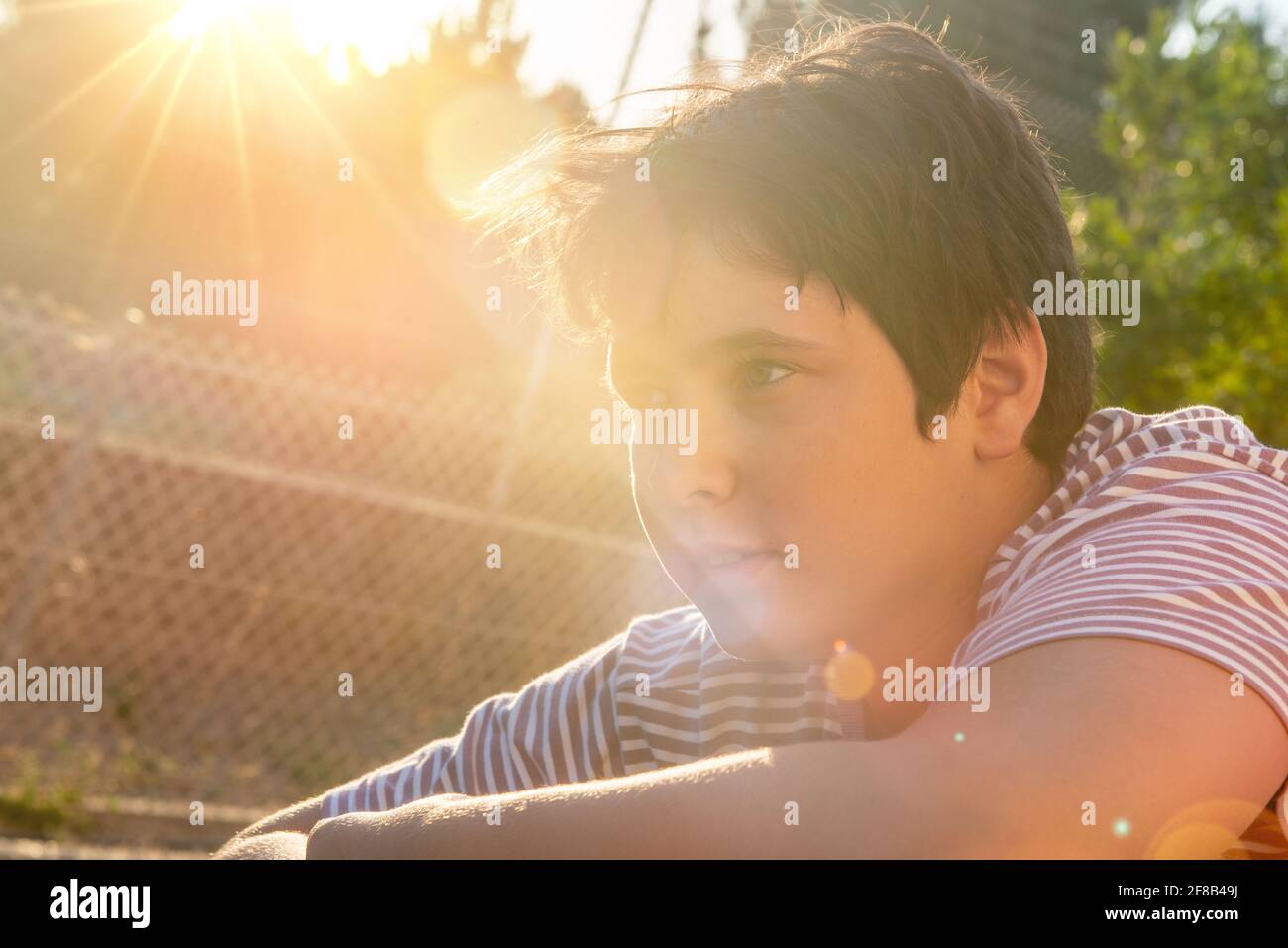 Happy handsome boy posing outdoors at sunset Stock Photo - Alamy