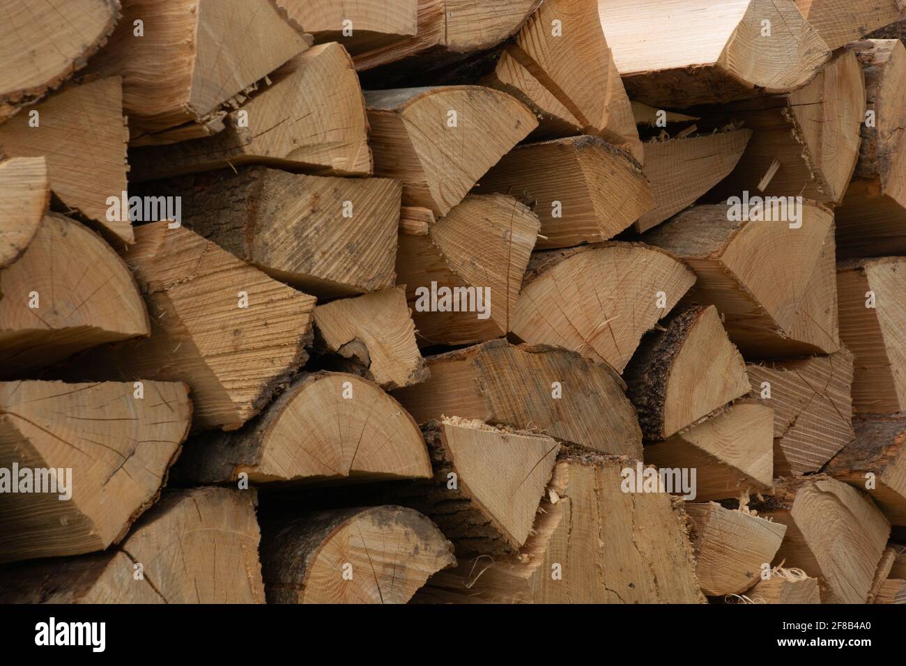 stacking wooden logs or firewood background Stock Photo - Alamy