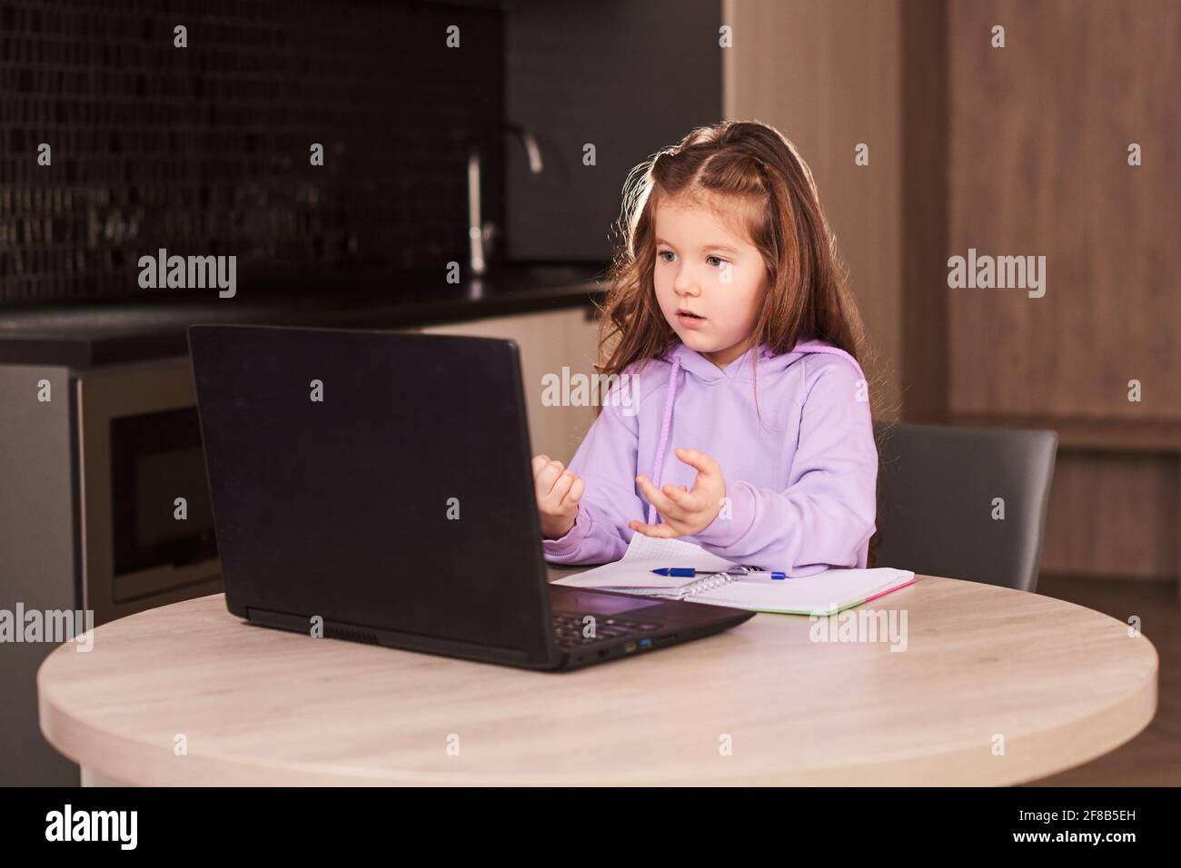 girl count on fingers in front of laptop. girl student online learning ...