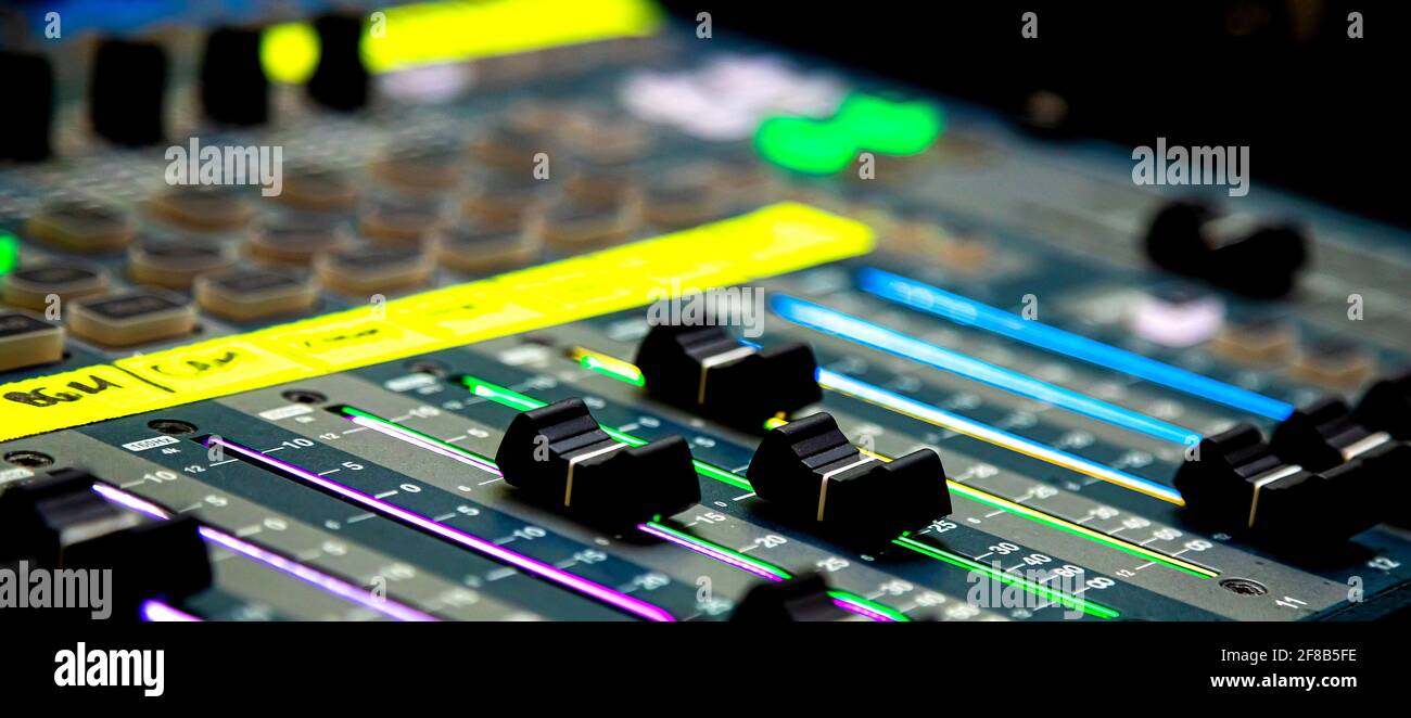Closeup shot of sliders and buttons on the audio mixing desk at a live ...