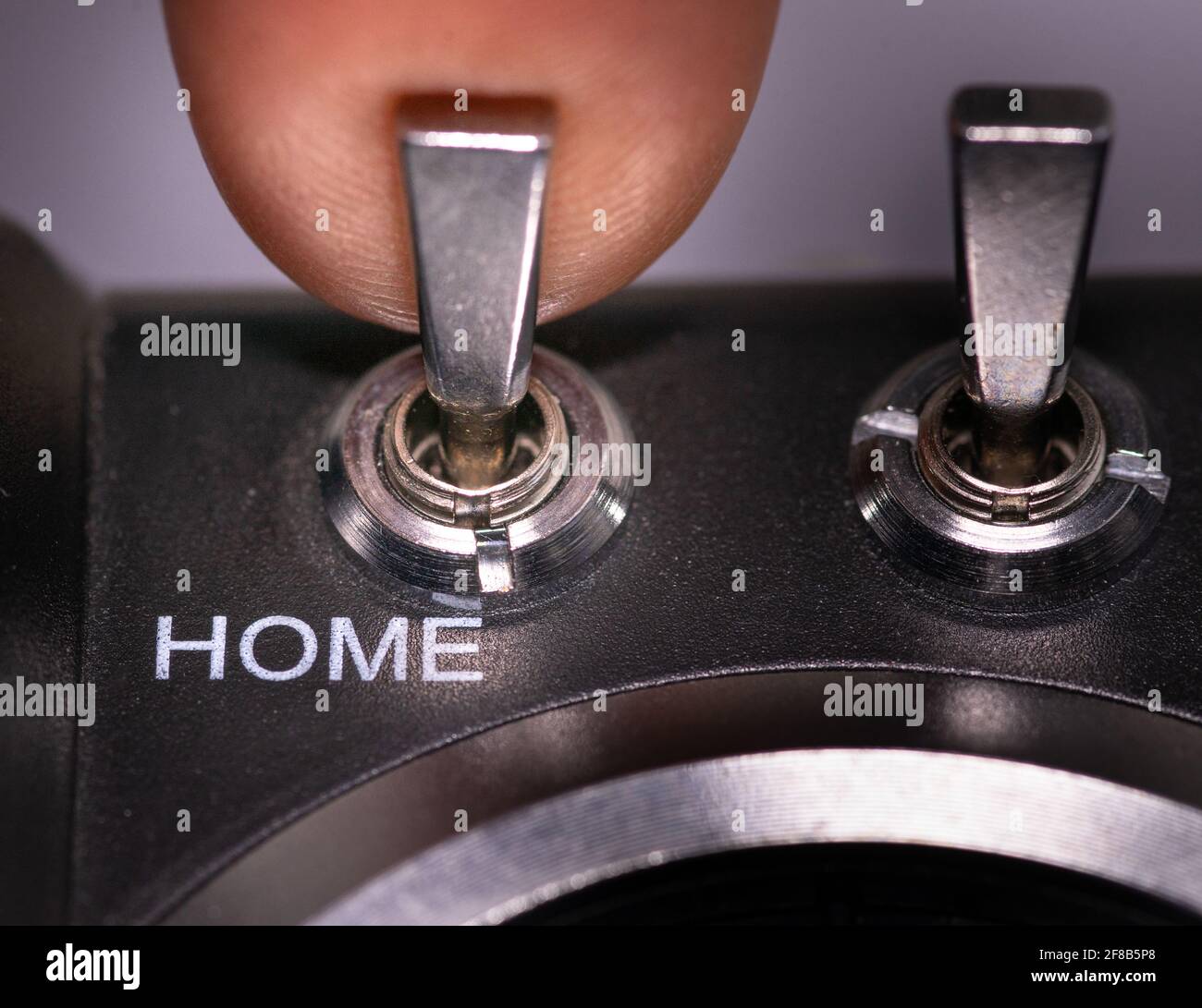 Closeup of a finger pressing the come home button of a drone on a ...