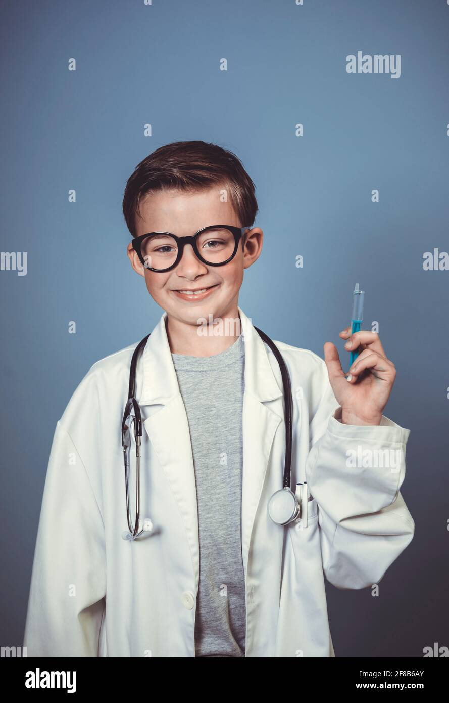 cool young boy is disguised as a doctor with a white doctor smock and ...