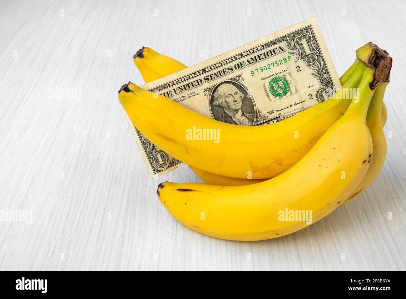 Bunch of yellow bananas with American currency. Conceptual image Stock ...
