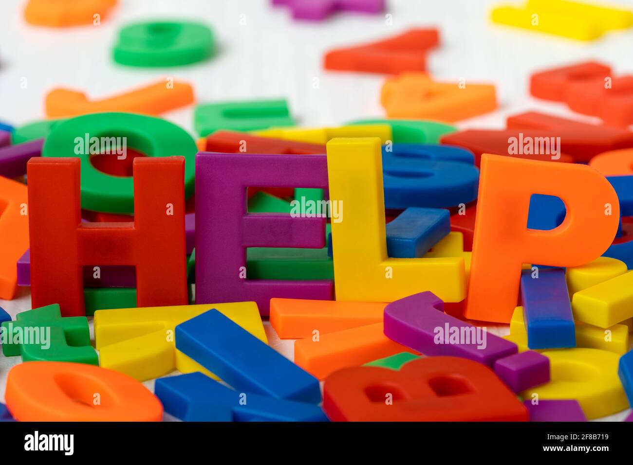 Plastic colored letters spelling word HELP. Close-up view Stock Photo ...