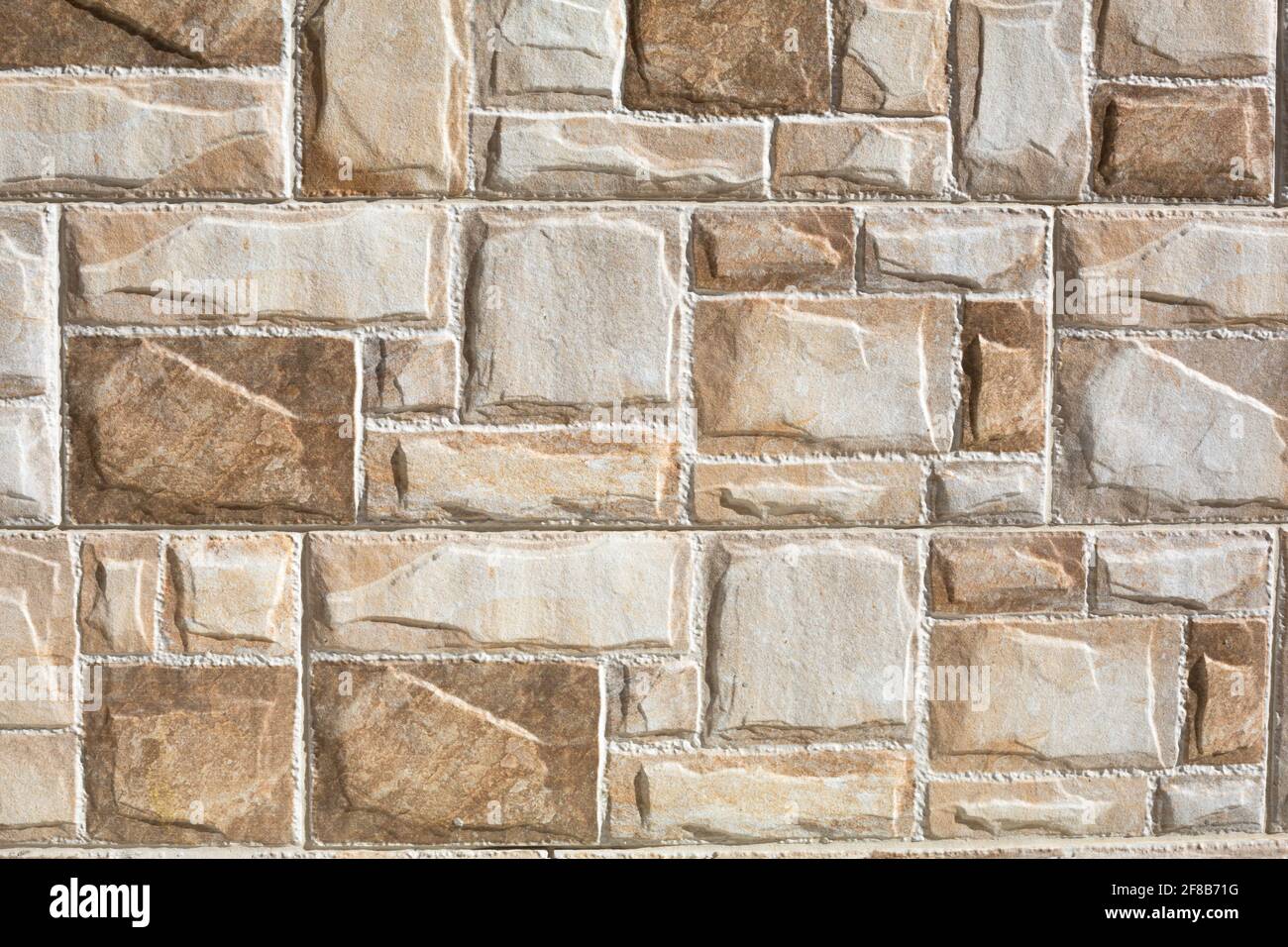 Stone tiles made of rectangular fragments of beige and sand color ...