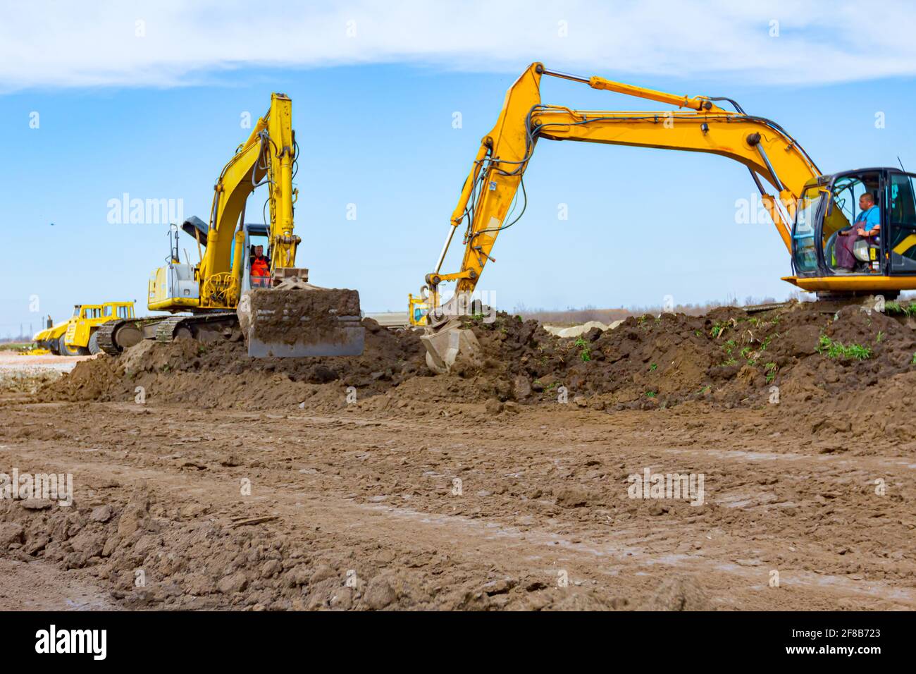 Two big excavators are remove layer of soil at construction site ...