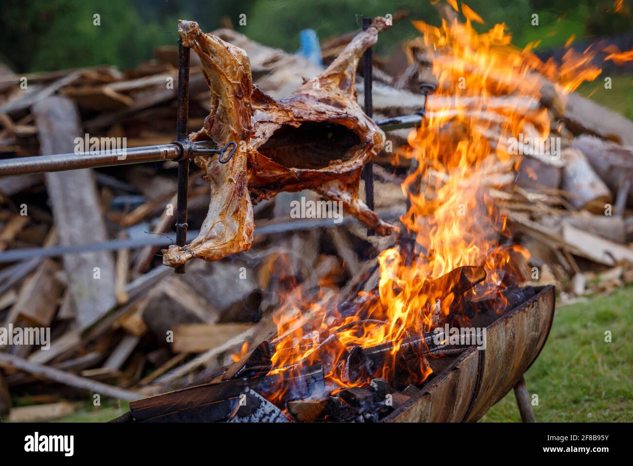 Traditional cooking mutton on fire at the festival Stock Photo - Alamy