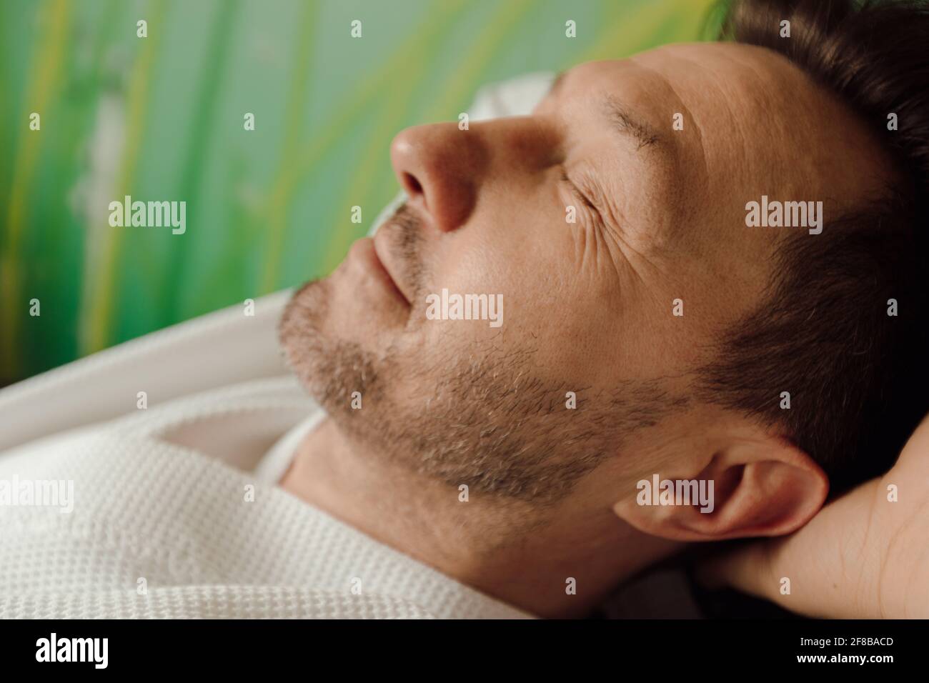 Close up portrait of handsome attractive smiling man enjoying free time ...