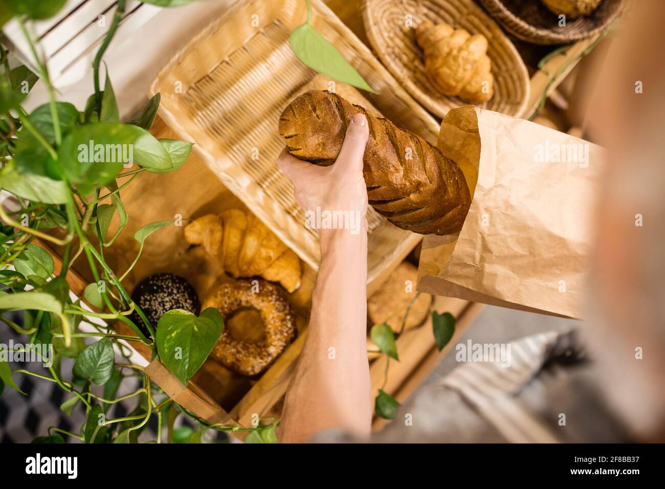 Man hand putting delicious bun in package Stock Photo - Alamy