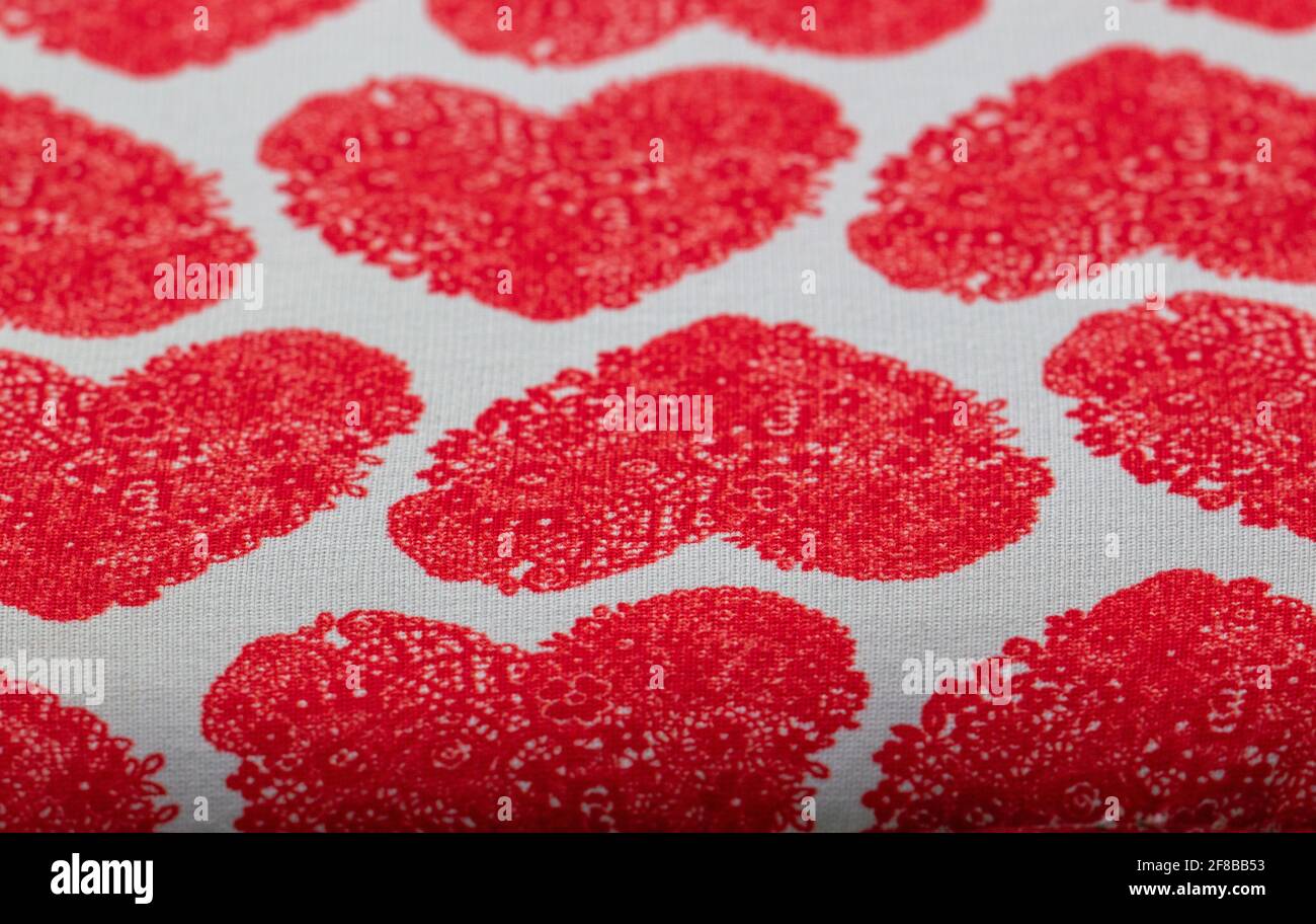 heart sign pattern on cotton fabric background. print of red hearts ...