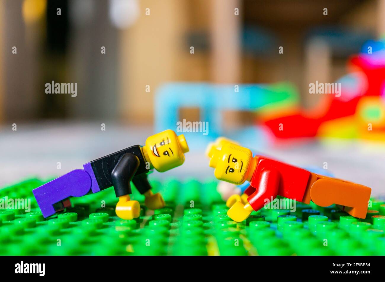 POZNAN, POLAND - Mar 27, 2021: Two Lego figurines doing push ups during ...