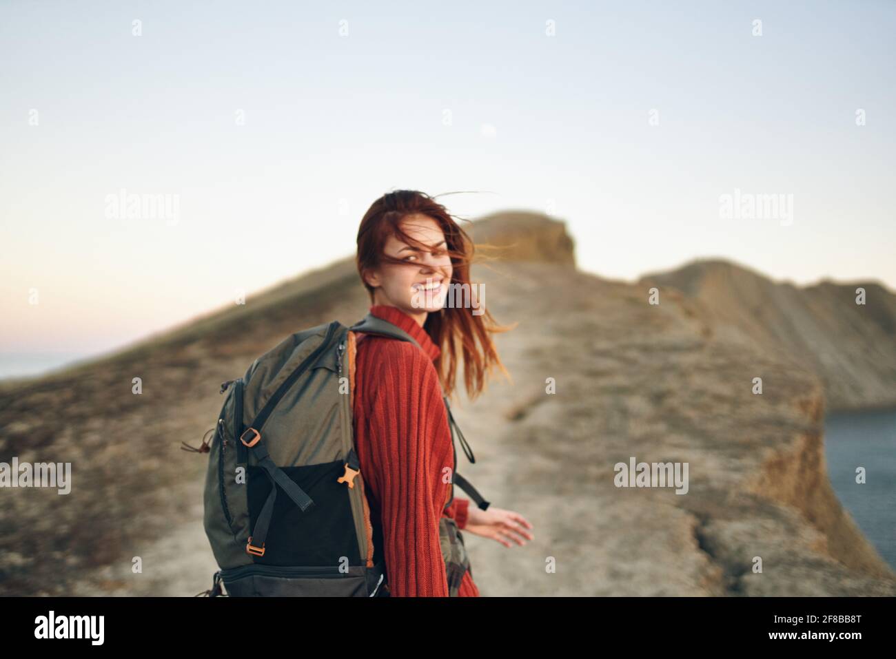 woman turned back and mountains in the distance travel tourism backpack ...