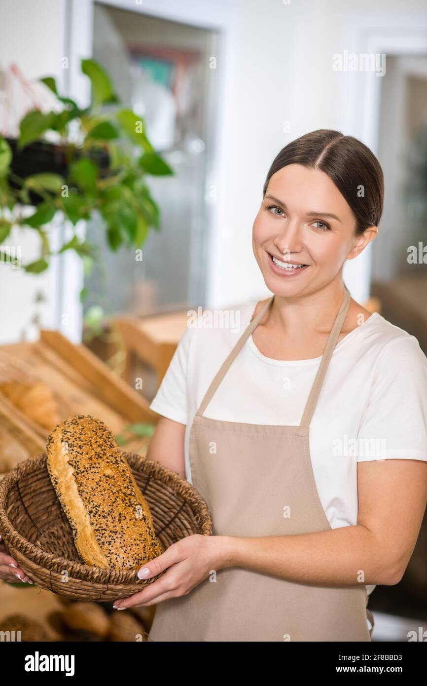Bread bakery offering woman hi-res stock photography and images - Alamy