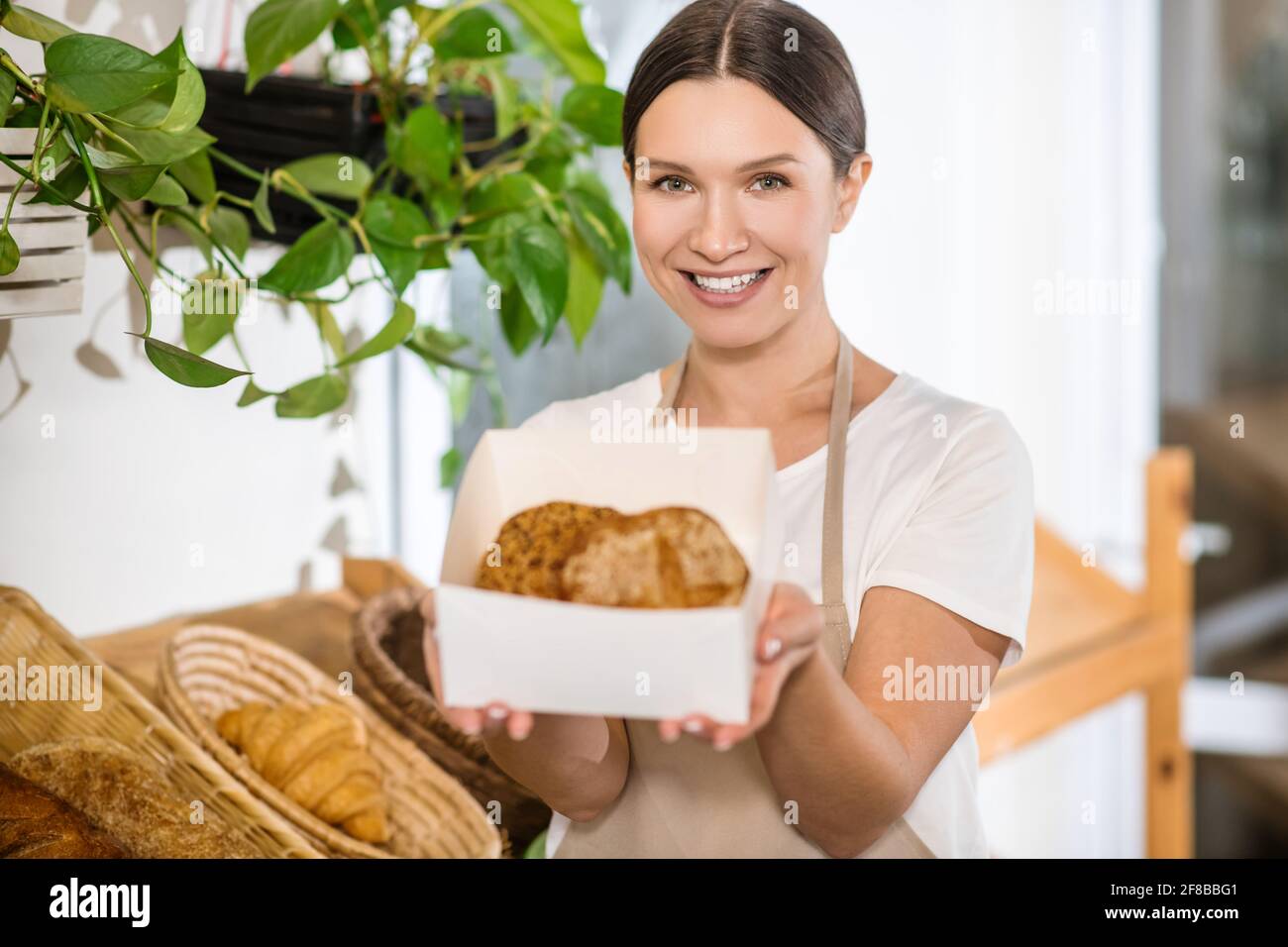 Woman showing bread hi-res stock photography and images - Alamy