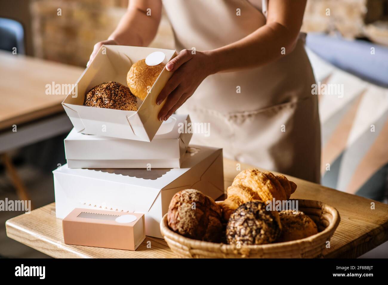 Female caring hands holding small box of buns Stock Photo - Alamy