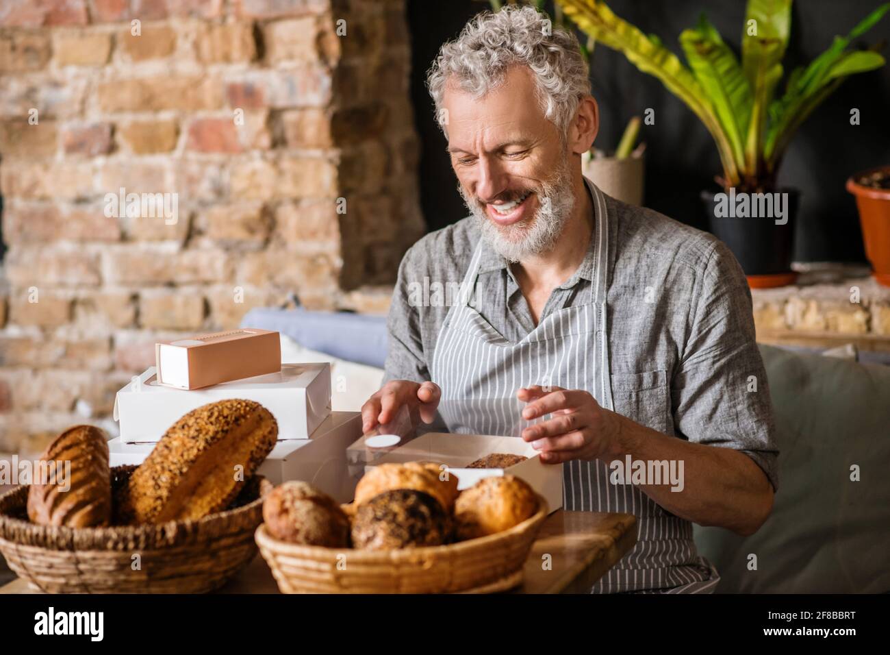 Bakery owner packing bread hi-res stock photography and images - Alamy